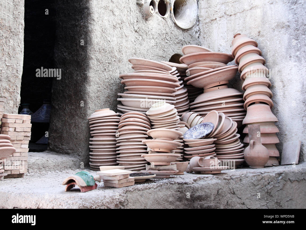 Preparing clay pottery for firing in adobe furnace. Traditional ...