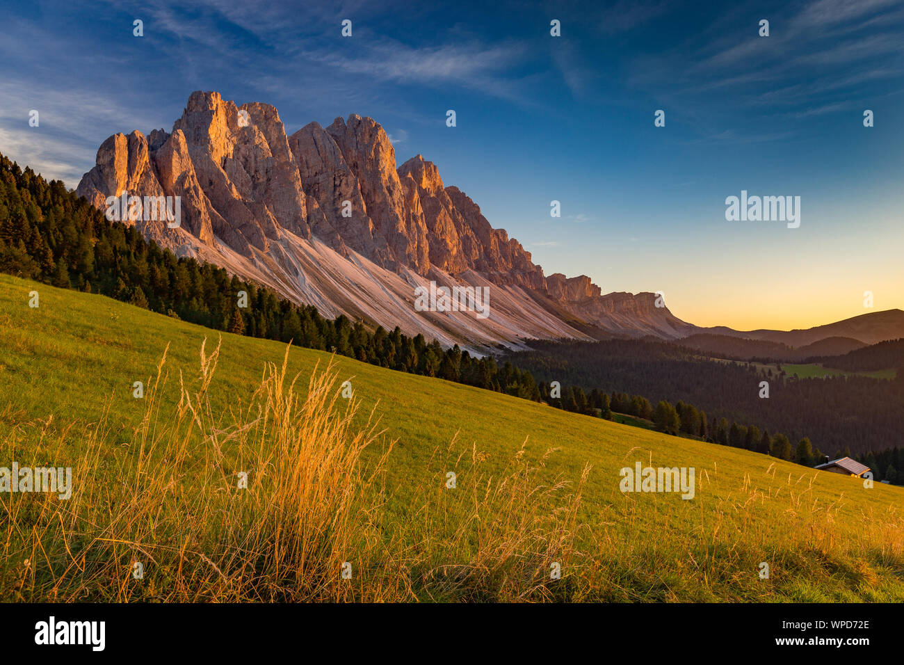 Sunset sunlight on the Odle massif, alpine grassland of the Funes ...