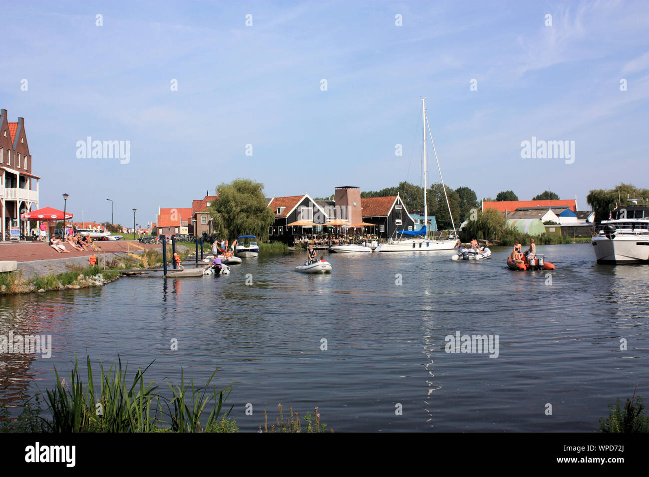 People enjoying outdoor dining in Volendam on a warm sunny day in ...