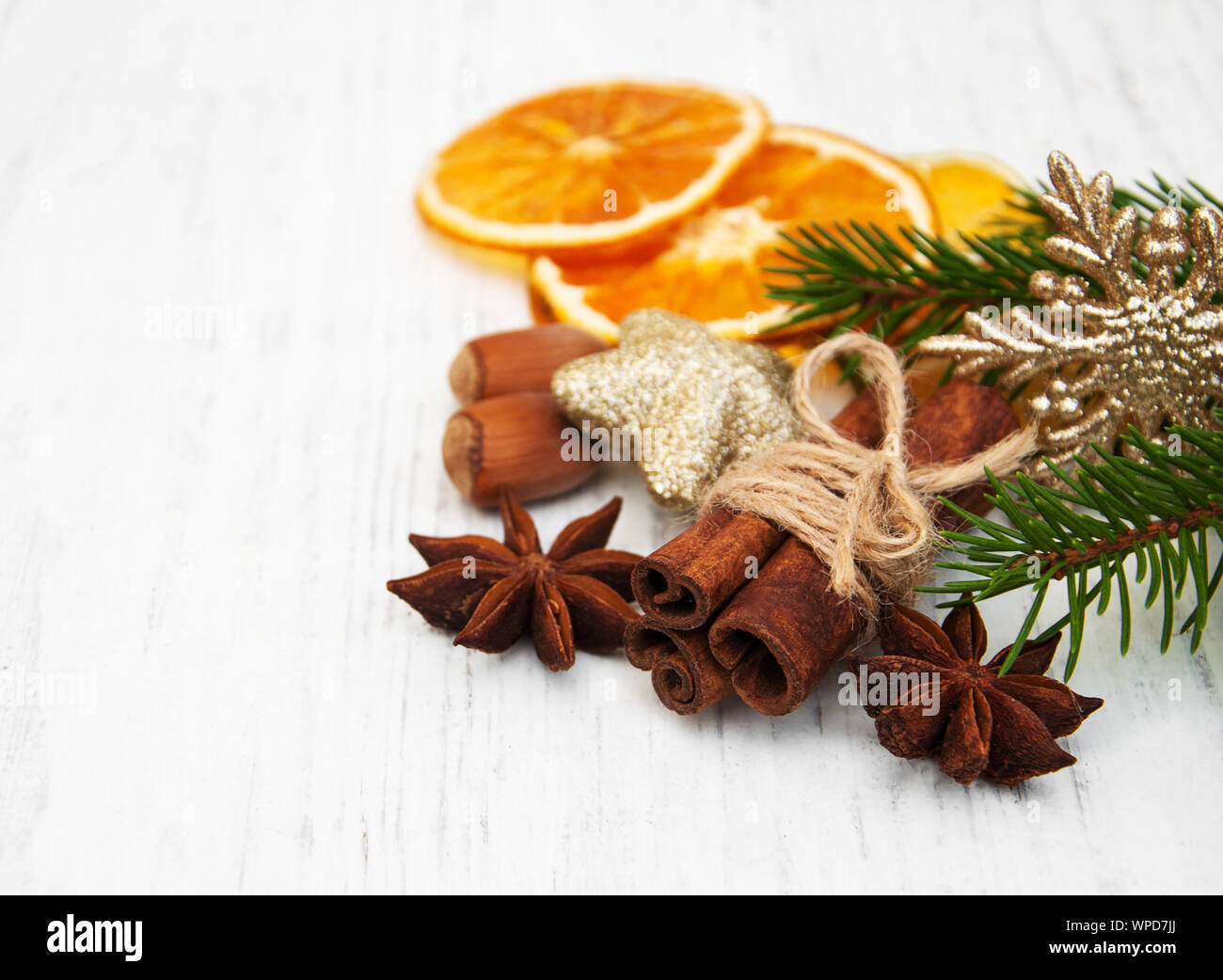 different kinds of spices nuts and dried oranges with christmas tree ...