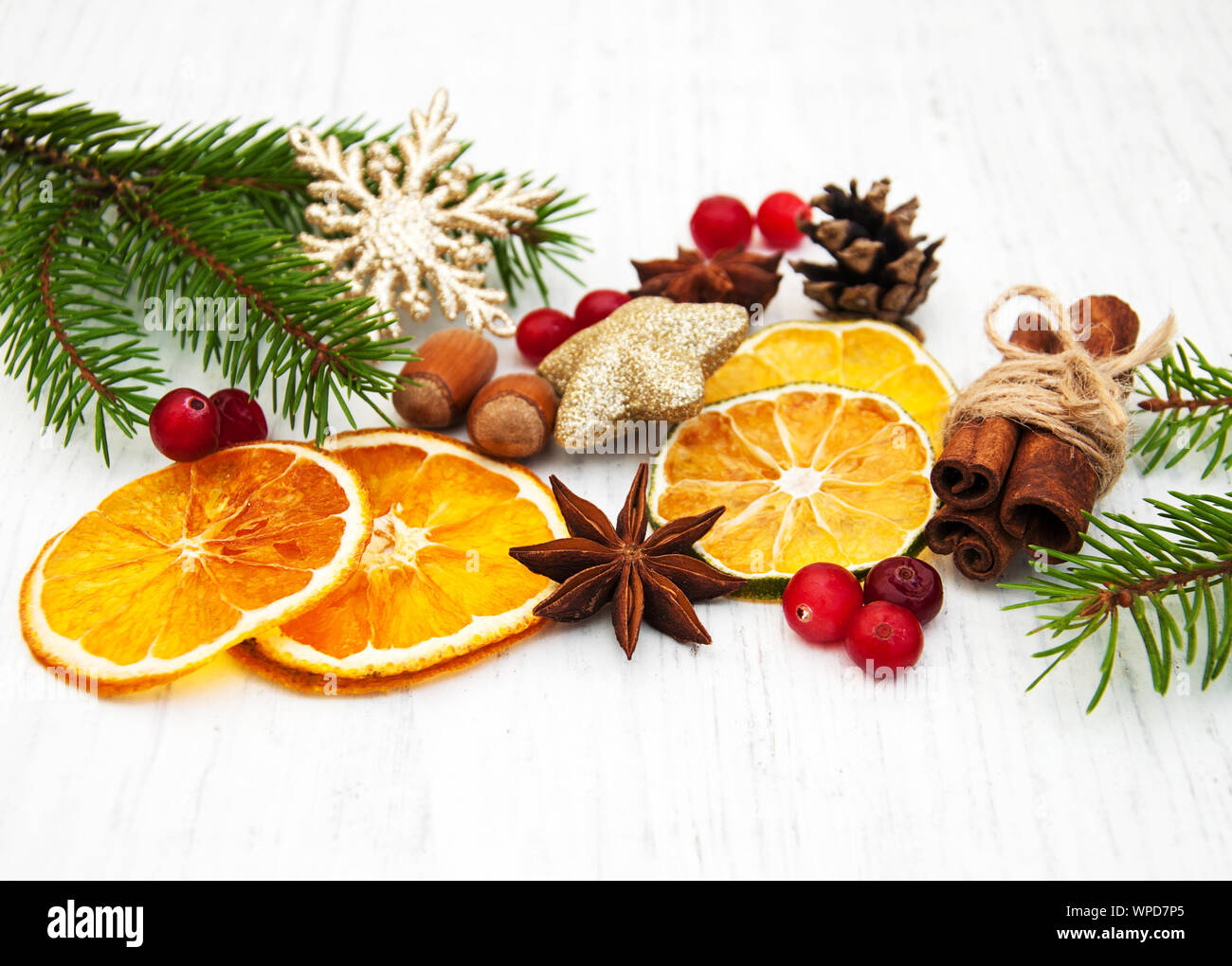 different kinds of spices nuts and dried oranges with christmas tree ...