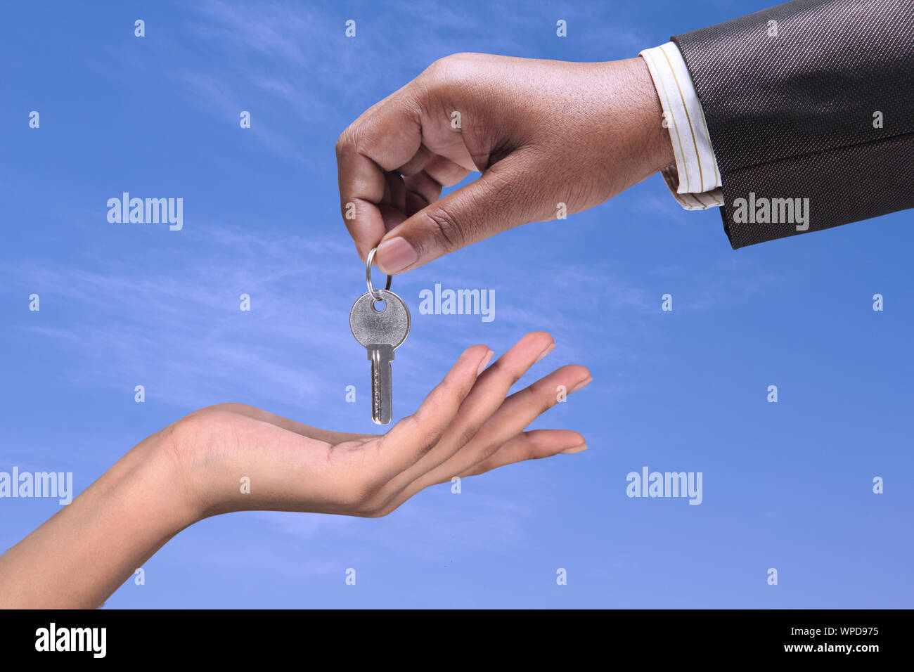 Salesman giving house key to a person Stock Photo - Alamy