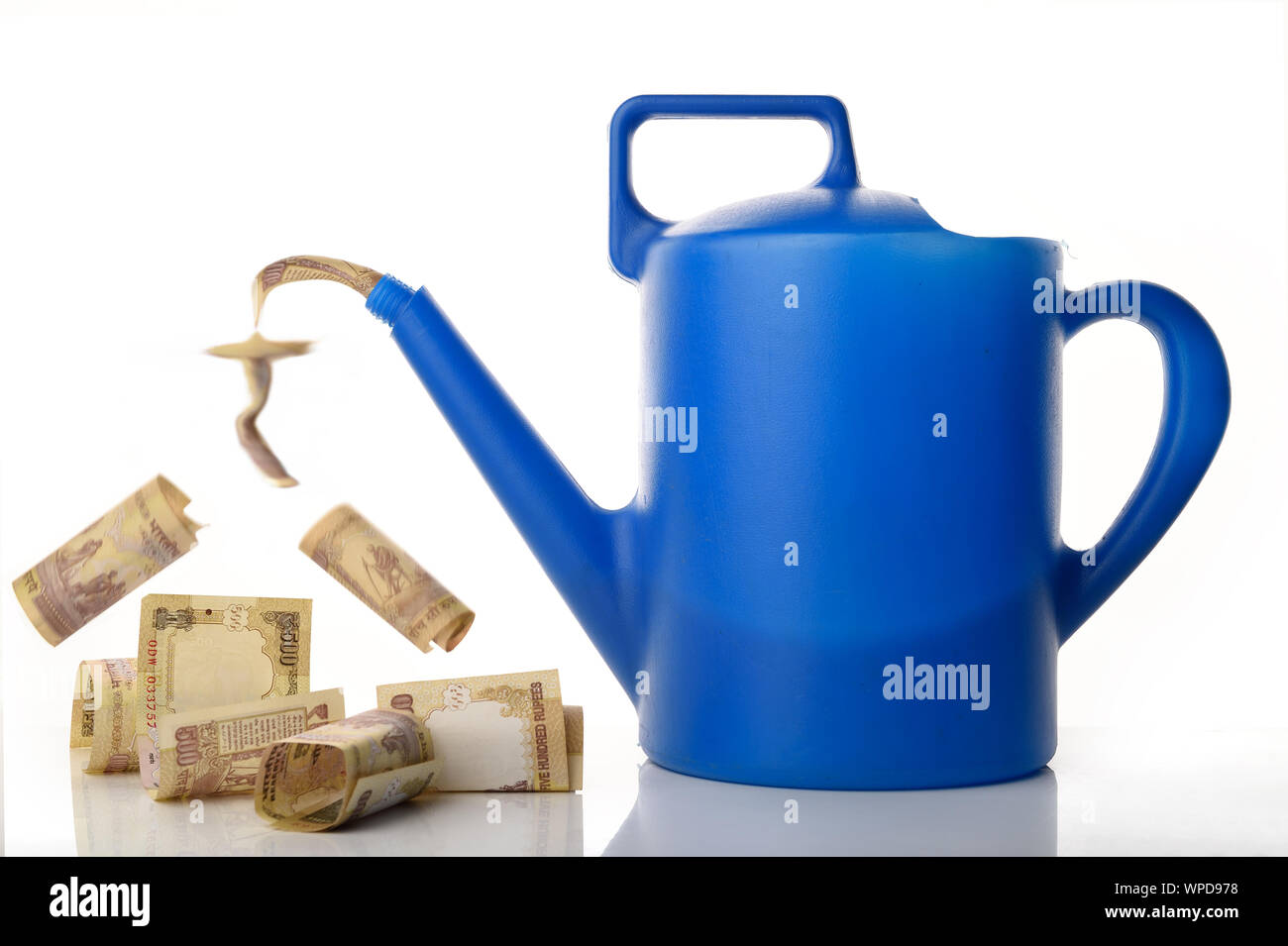 Paper money coming out of watering can as concepts of investment Stock ...