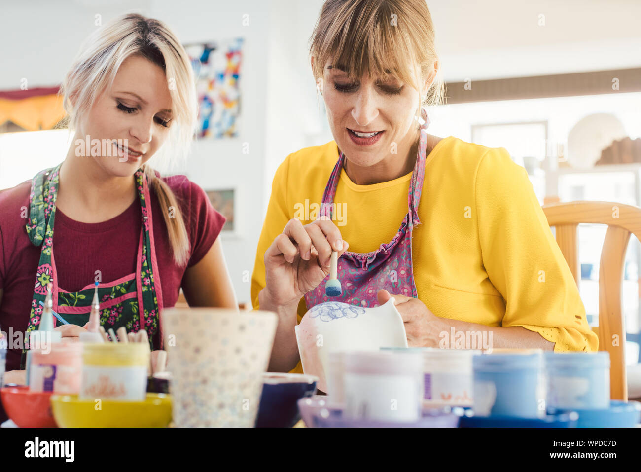 Women in DIY workshop coloring and decorating their own ceramic Stock ...