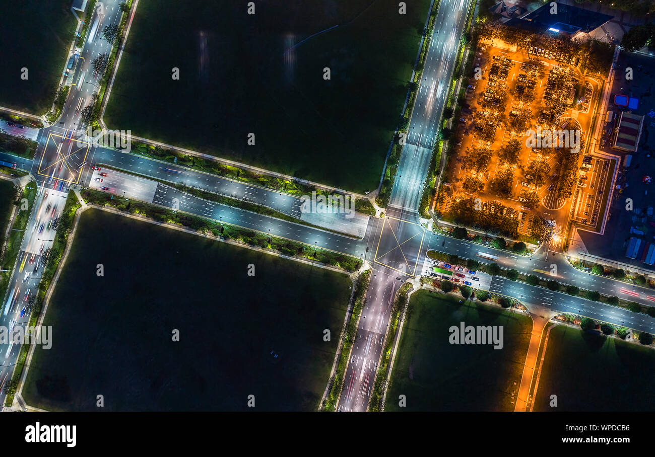 aerial view of parallel roads filled with traffic in the night ...