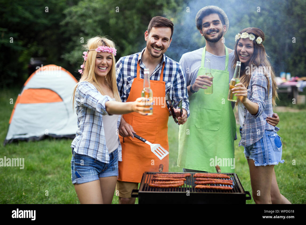 Group of friends making barbecue in the nature Stock Photo - Alamy