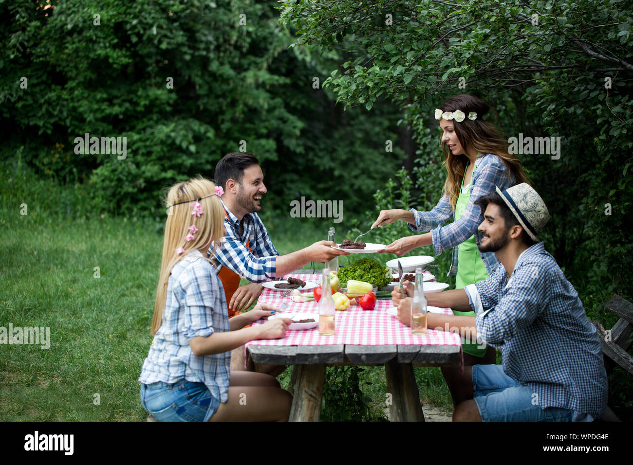 Group of friends having fun in nature doing bbq Stock Photo - Alamy