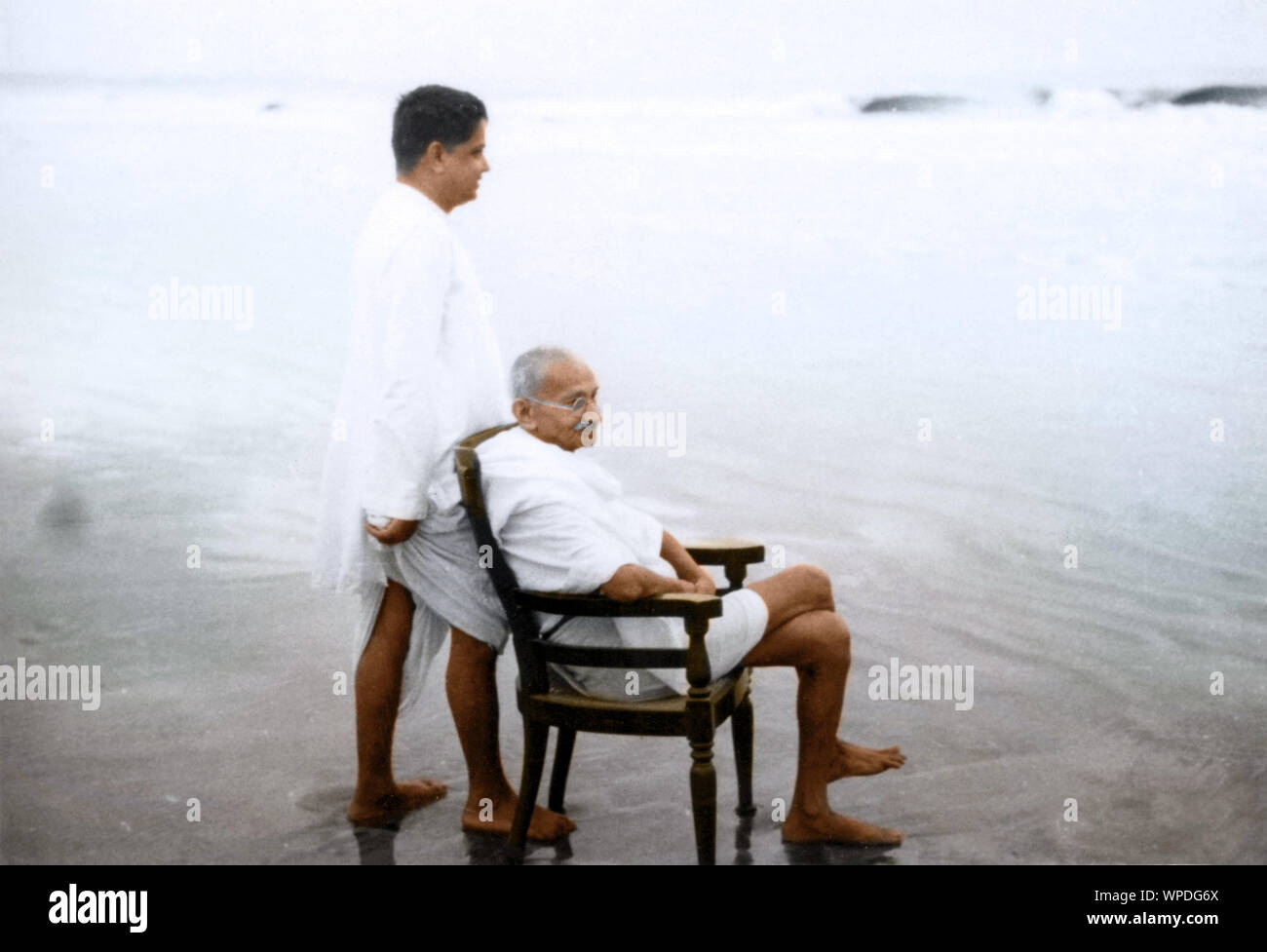 Mahatma Gandhi sitting on chair and Devdas Gandhi, Juhu Beach, Bombay ...