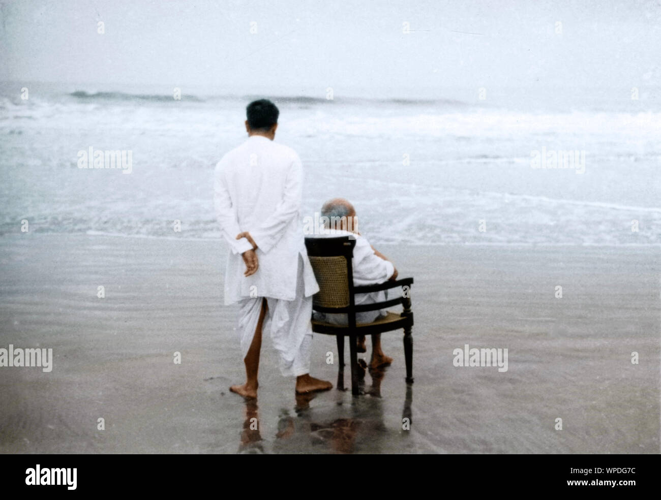 Mahatma Gandhi sitting on chair and Devdas Gandhi on Juhu Beach, Bombay ...