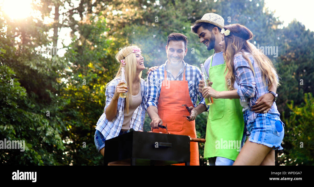 Happy friends enjoying barbecue party Stock Photo - Alamy