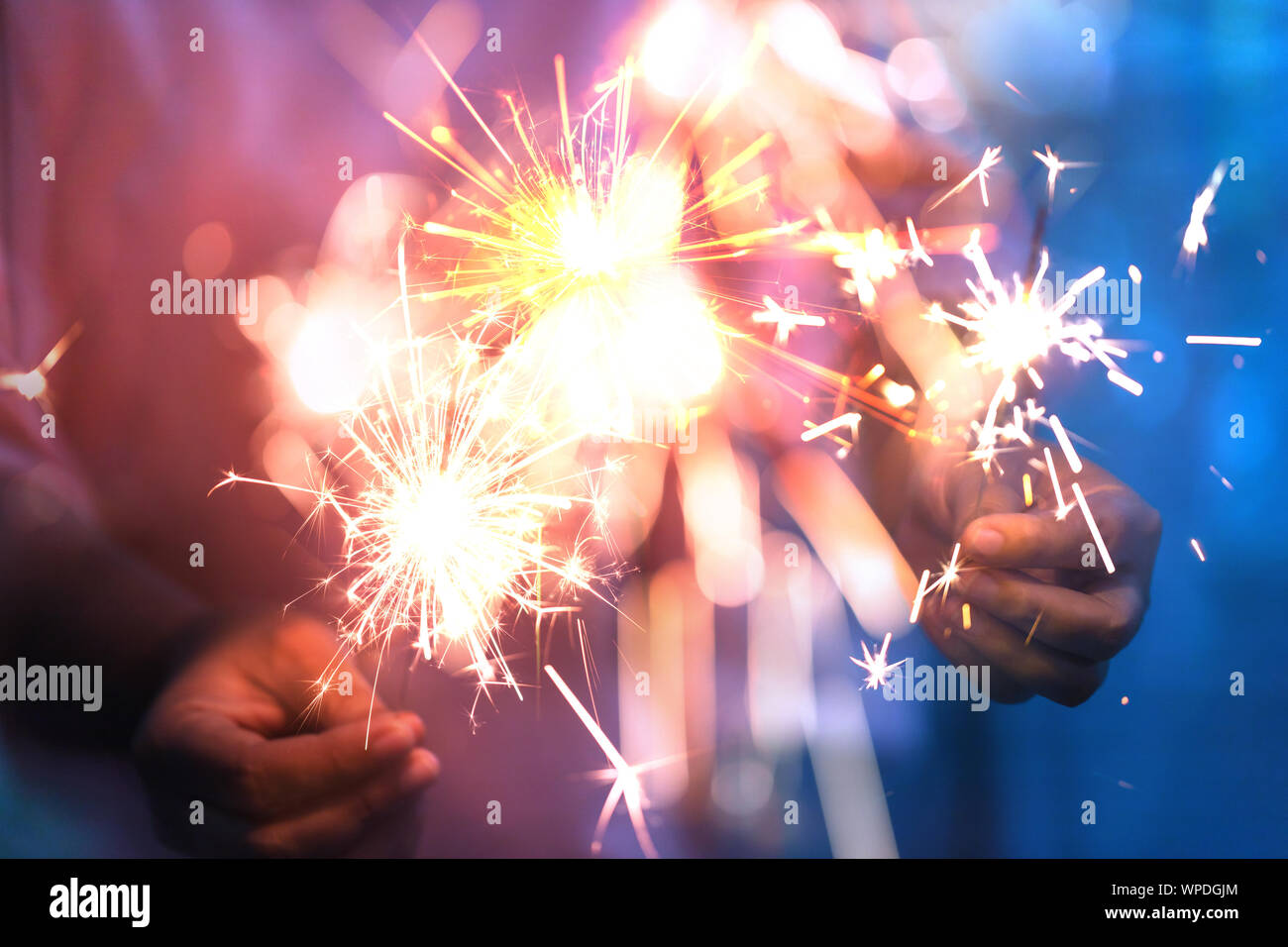 Hand of woman holding firework firework pyrotechnics and bokeh with ...
