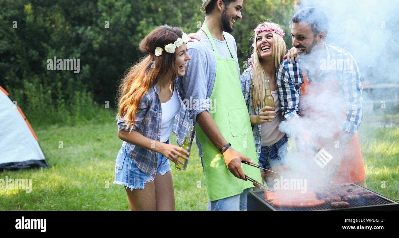 group of friends having outdoor garden barbecue Stock Photo - Alamy