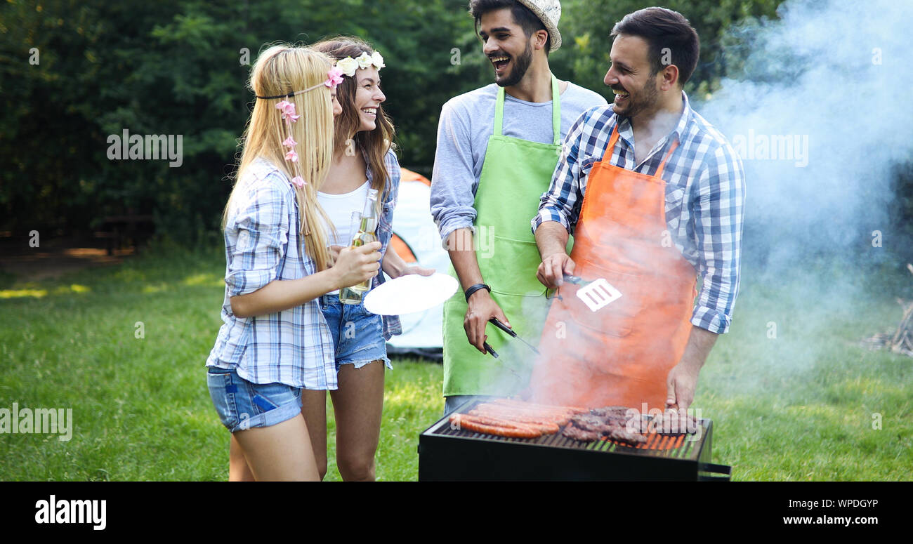 Friends spending time in nature and having barbecue Stock Photo - Alamy