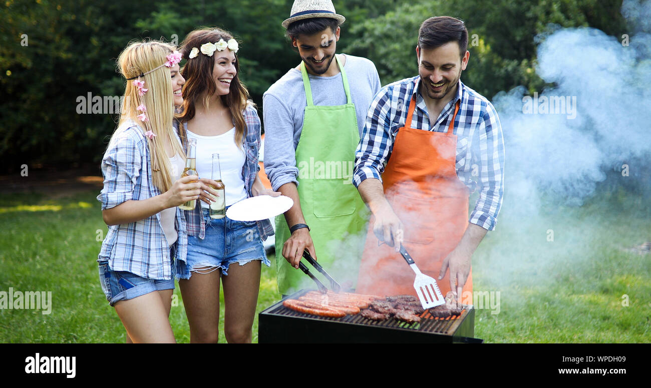 Happy people having camping and having bbq party Stock Photo - Alamy
