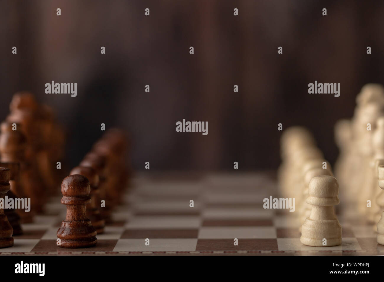 wooden chess endways on the board with wood background. Select focus ...