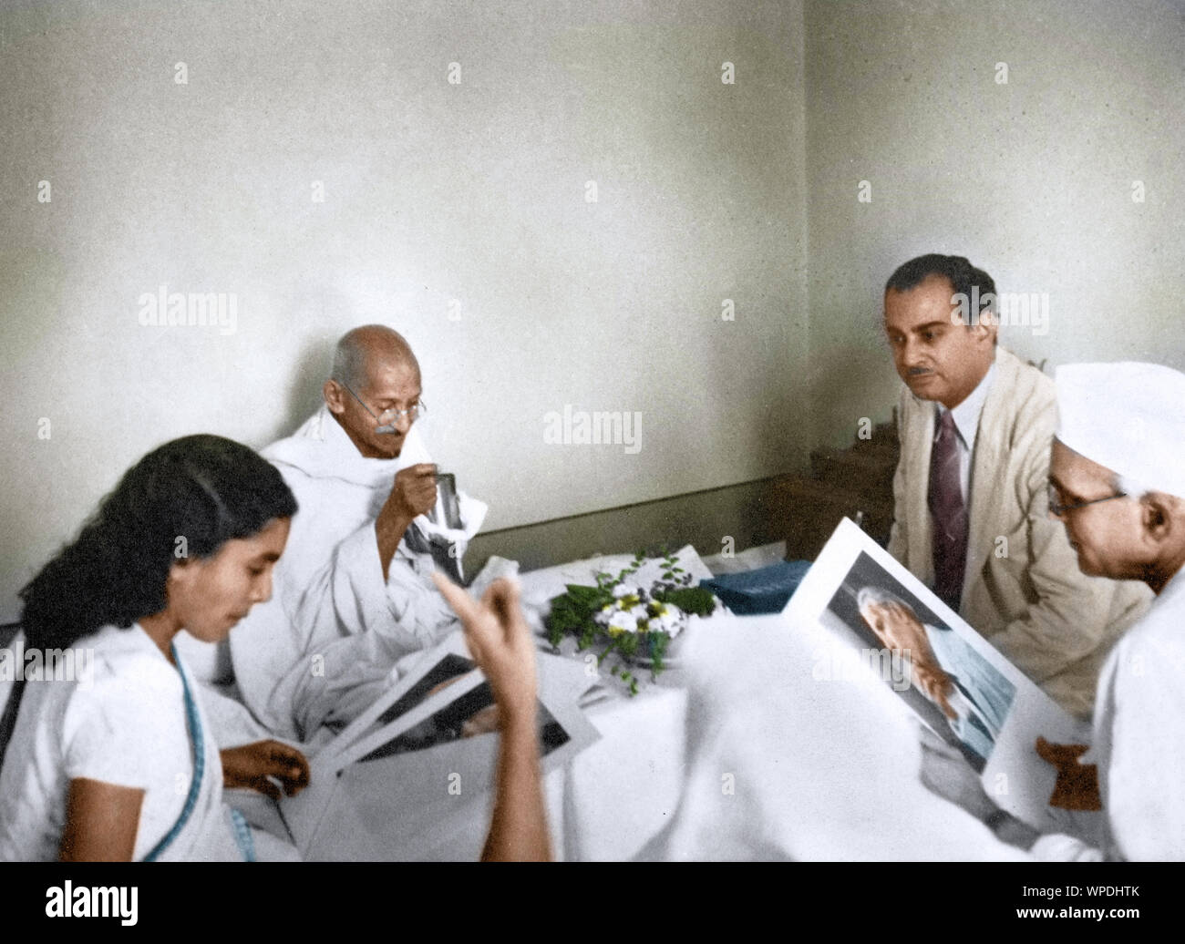 Photographer DRD Wadia showing photographs to Mahatma Gandhi, Bombay ...