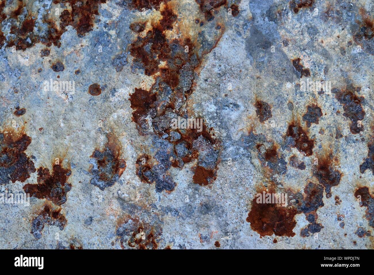 Rusty metal textures on aged and weathered walls in a detailed close up ...