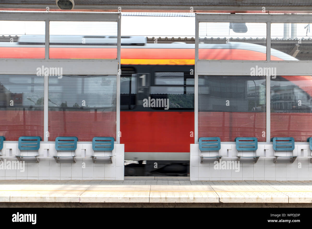 The train passes through the station with platforms. A view of a moving ...