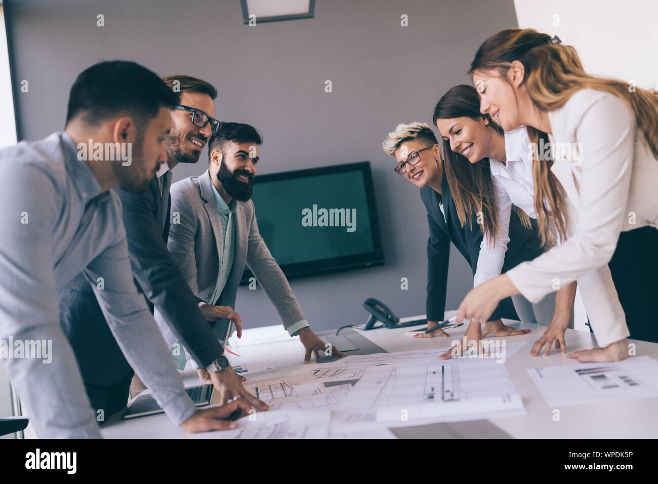 Group of architects working on new project Stock Photo - Alamy