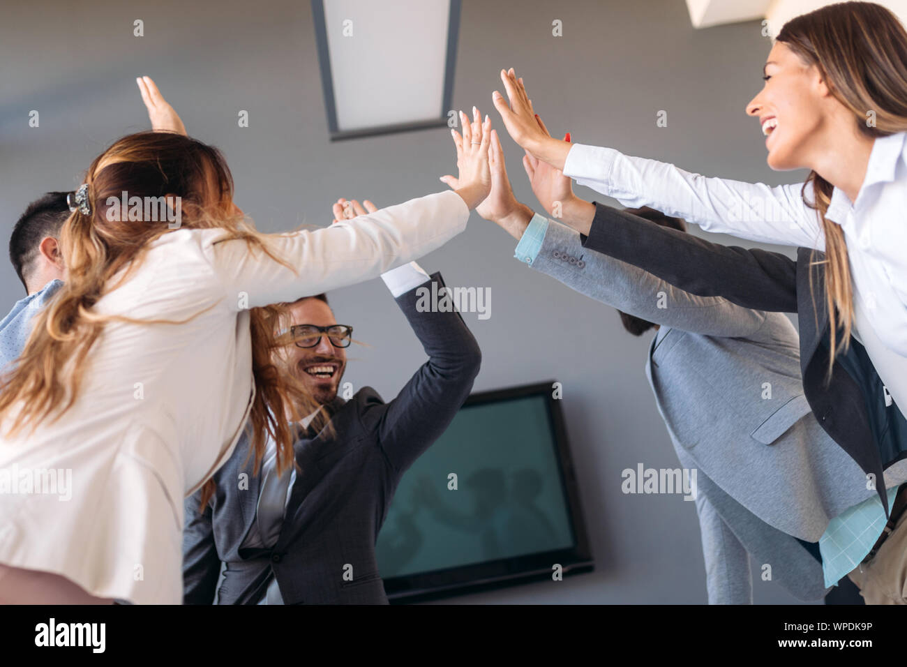 Business team celebrating a triumph with arms up Stock Photo - Alamy