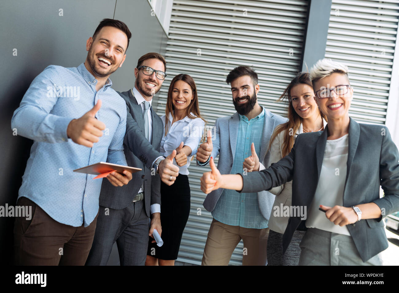 Business team celebrating a triumph with arms up Stock Photo - Alamy
