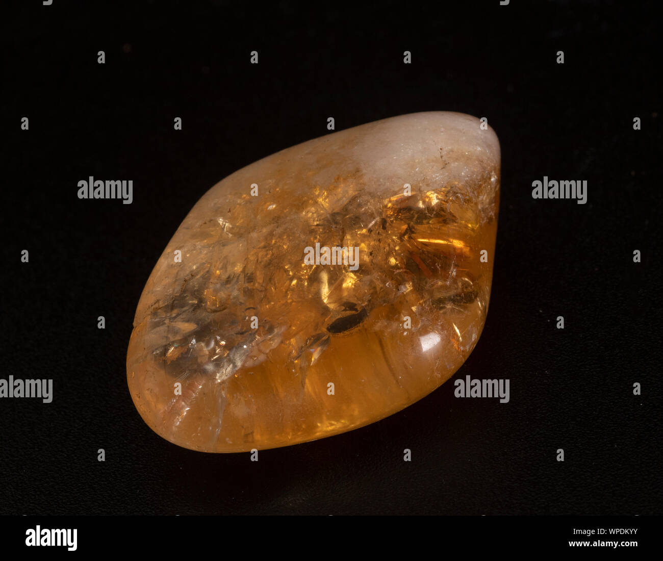 polished citrine in front of black background Stock Photo - Alamy
