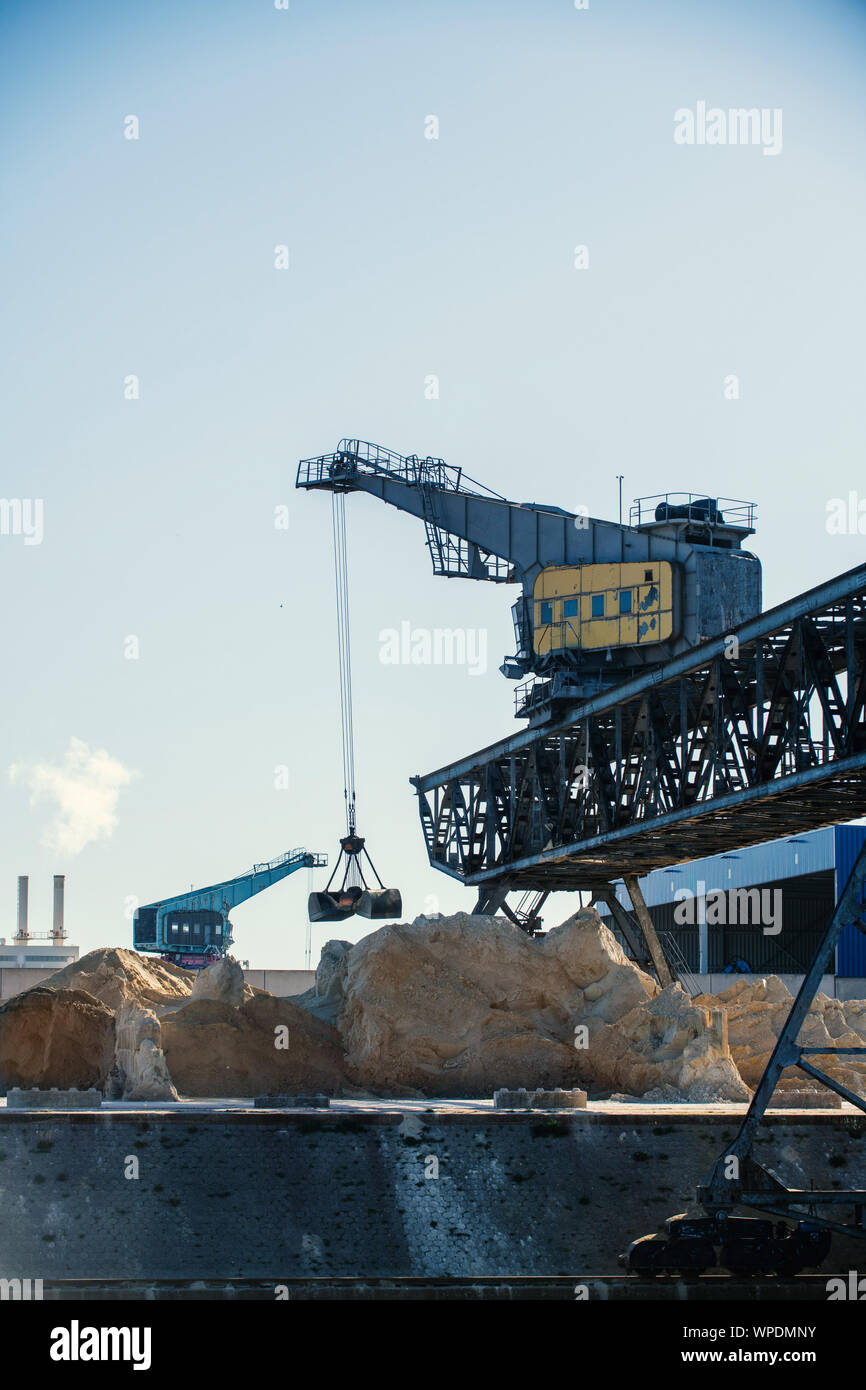 Industrial scene of crane loading sand Stock Photo - Alamy