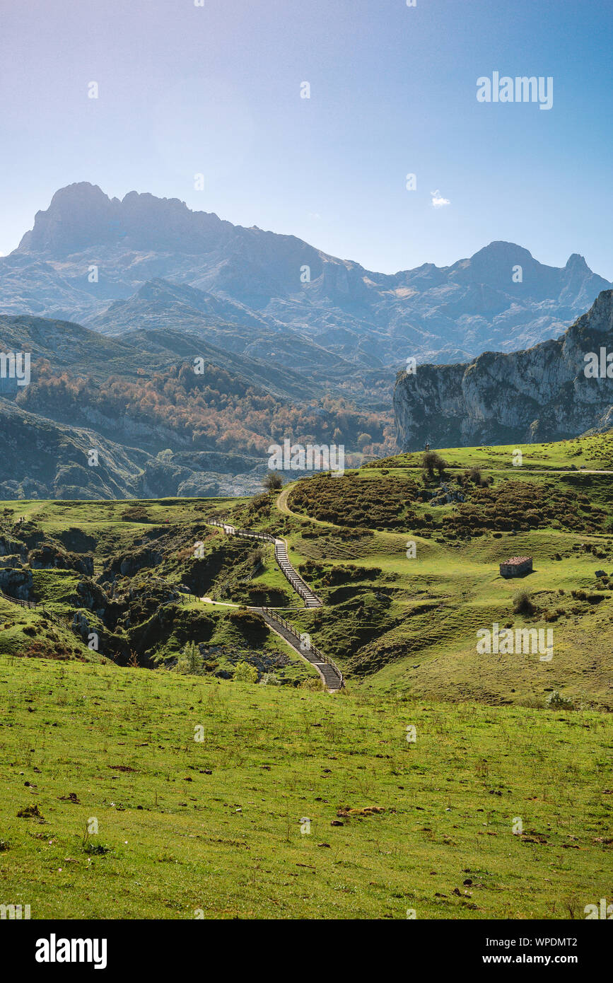 Landscape with path between mountains Stock Photo - Alamy