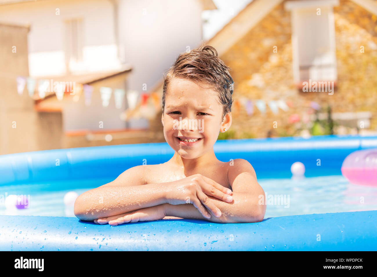 Happy boy smiling portrait on the pool border Stock Photo - Alamy