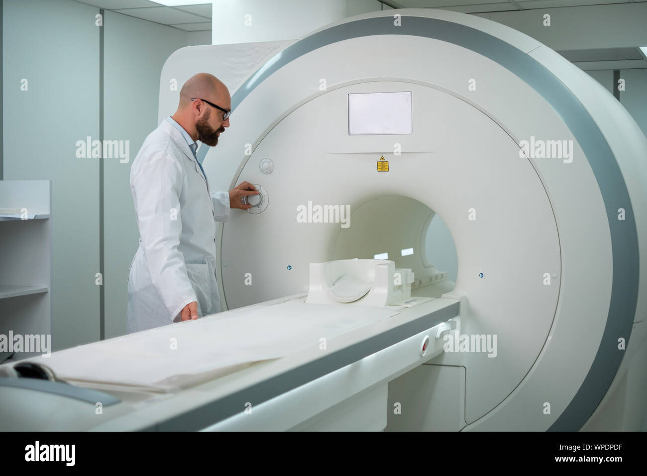 Doctor preparing MRI scanner in a hospital Stock Photo - Alamy