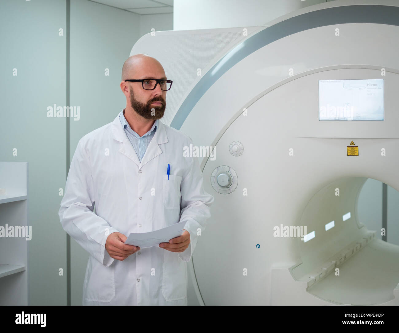 Doctor with a patient medical card near MRI scanner in a hospital Stock ...