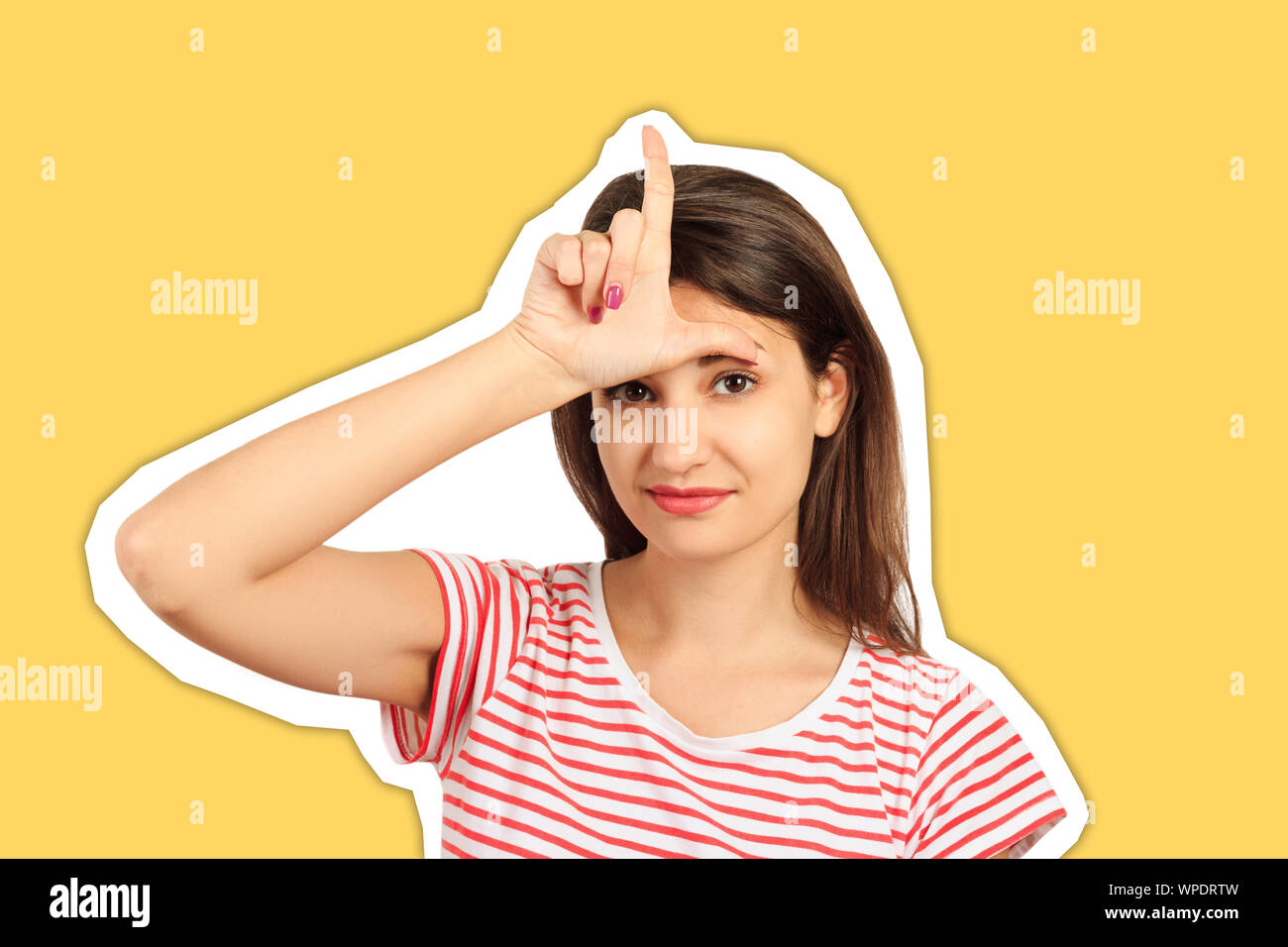 girl smiling showing loser sign on forehead. emotional girl isolated on ...