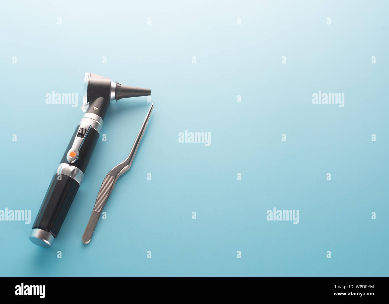 Otoscope with ear instrument on blue background Stock Photo - Alamy