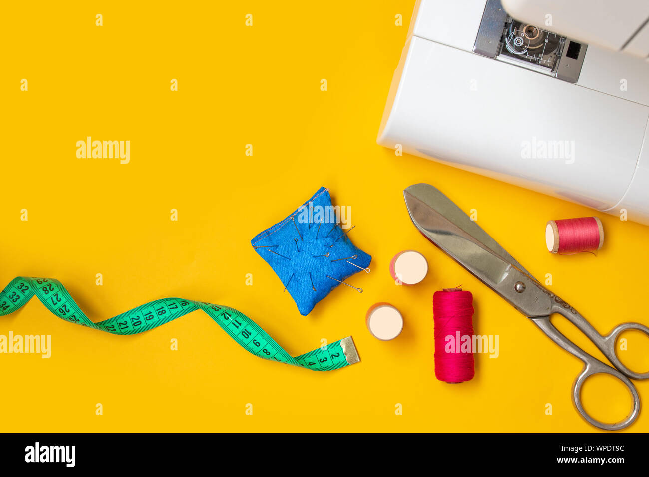 Close up foot of sewing machine and handcraft accessories. Workplace of ...