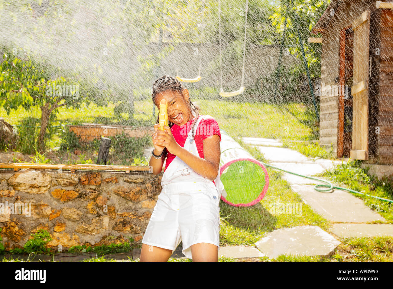 Girl shooting water pistol hi-res stock photography and images - Alamy