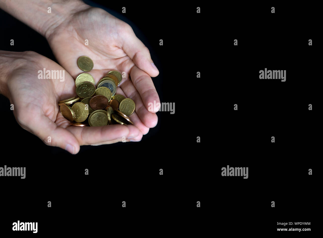 Man hands holding coins hi-res stock photography and images - Alamy