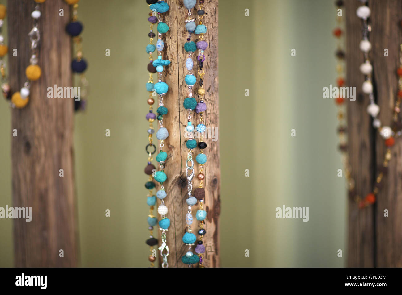 Long strings of beads on a wooden bracket on the window of a souvenir ...