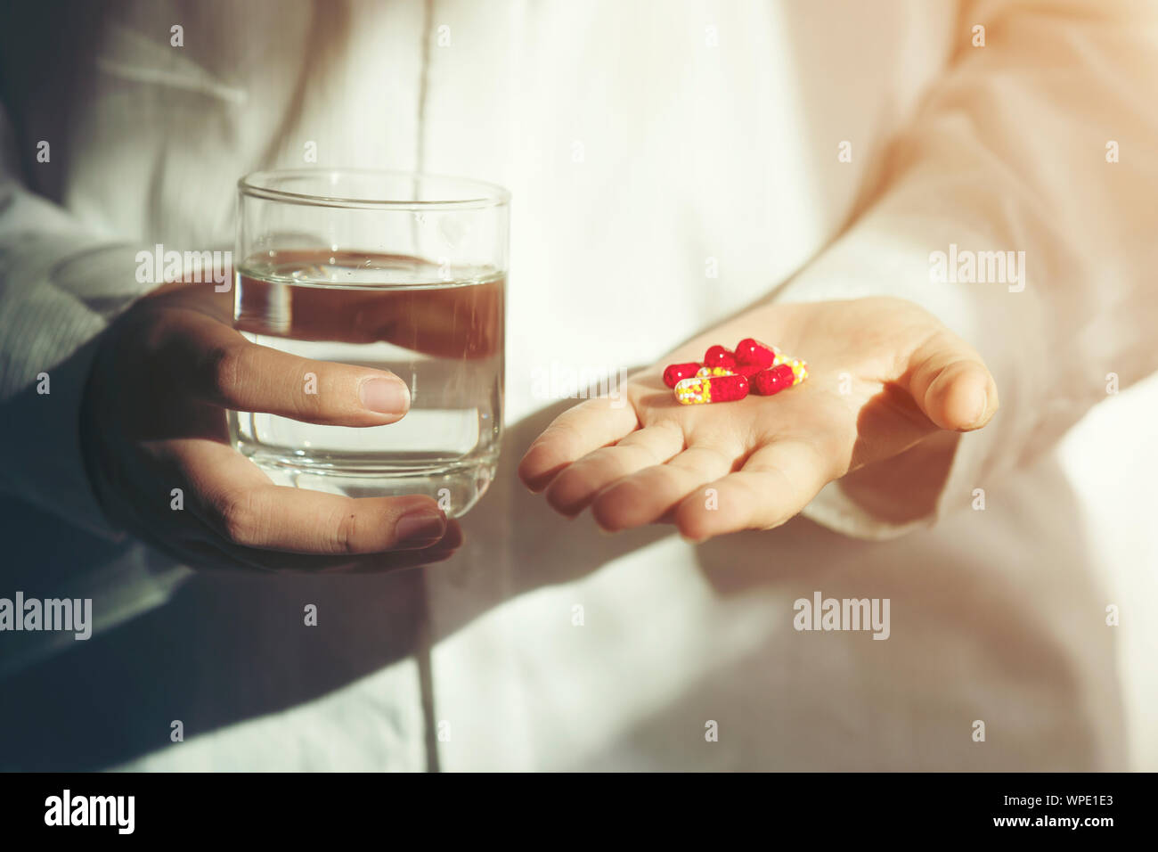 Patient hand holding medical drug with glass. Concept of healthcare ...