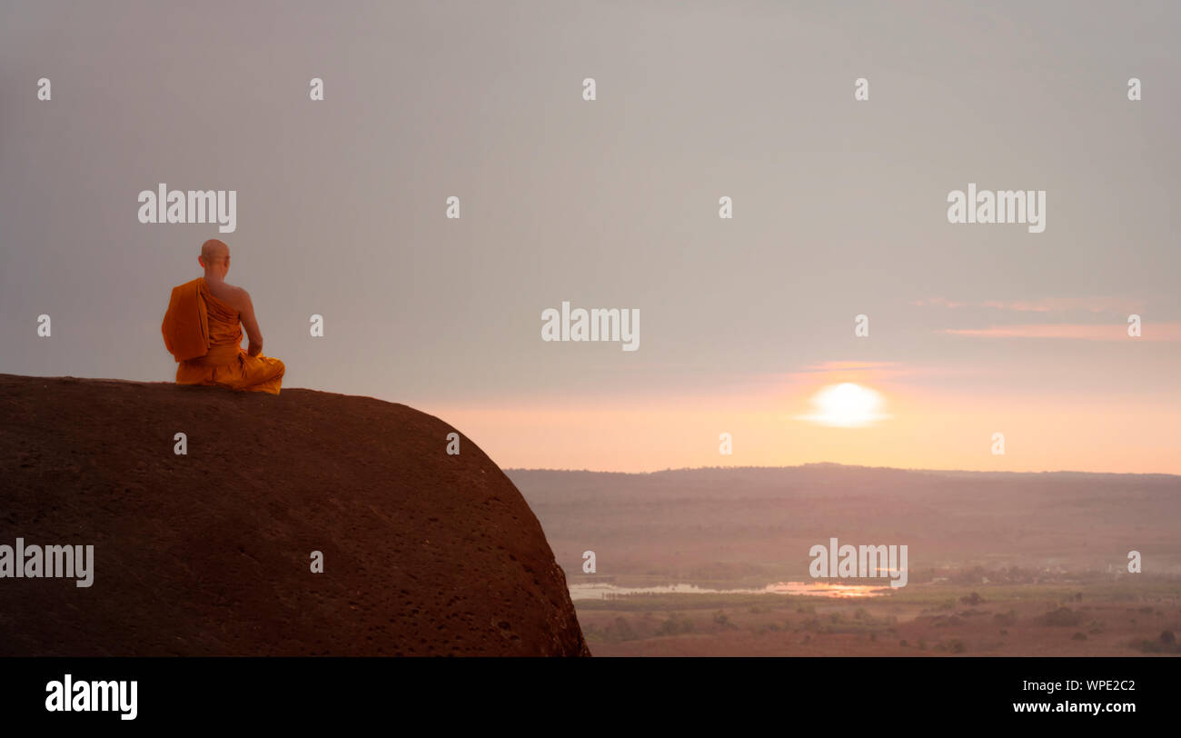 Buddhist monk in meditation at beautiful sunset or sunrise background ...
