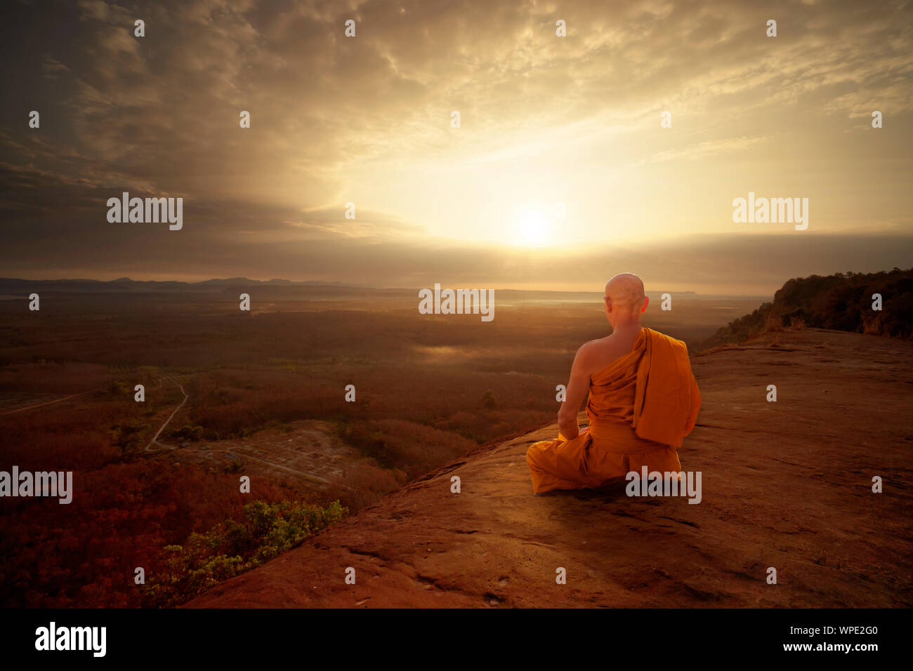 Buddhist monk in meditation at beautiful sunset or sunrise background ...