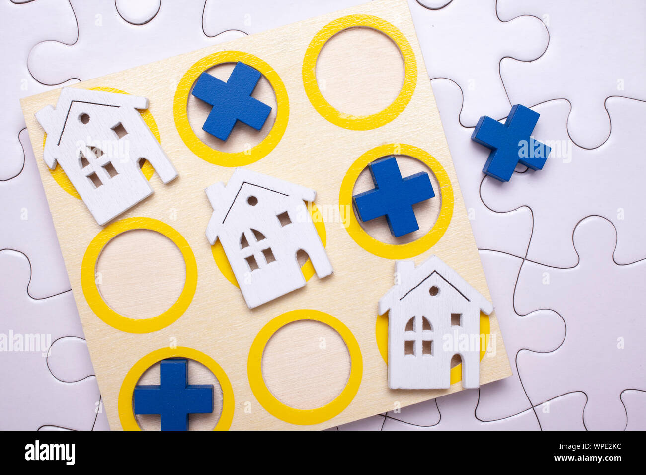 tic tac toe using house shape on puzzle background- real estate ...