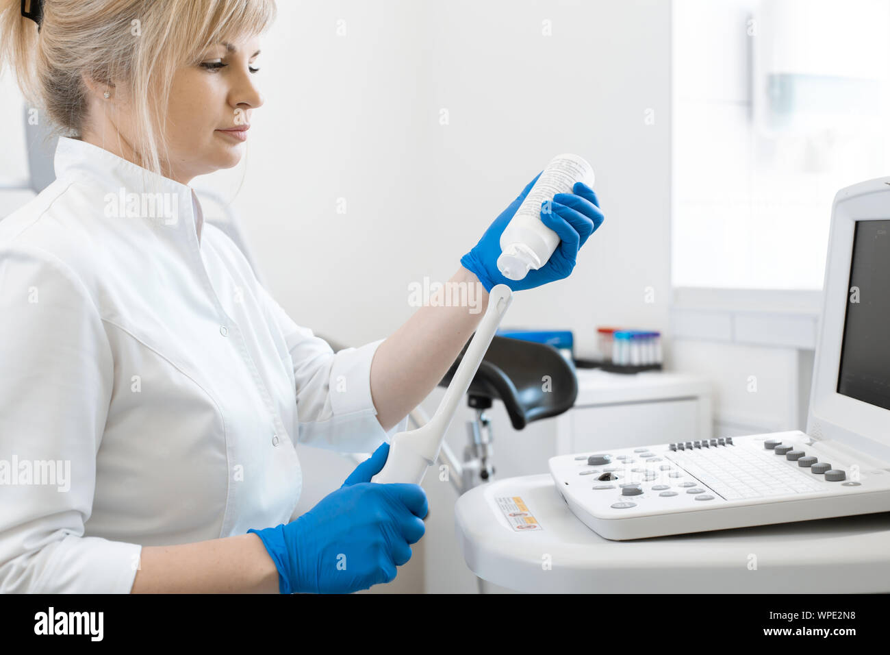 the gynecologist holds the sensor for vaginal examination with an ...