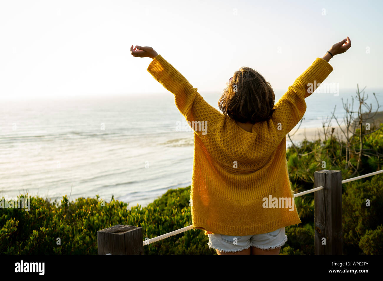 Alone female celebrating with raised arms high up in hi-res stock ...