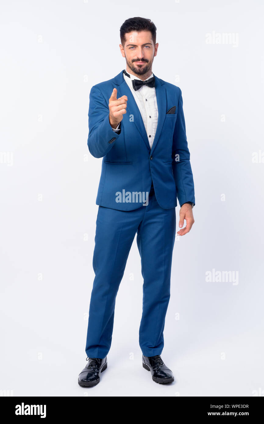 Full body shot of young handsome bearded businessman pointing at camera Stock Photo - Alamy