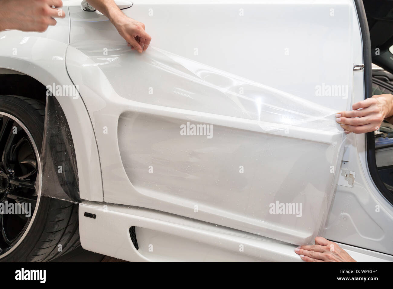 Retrofitting the car with a solid transparent protective film, the ...