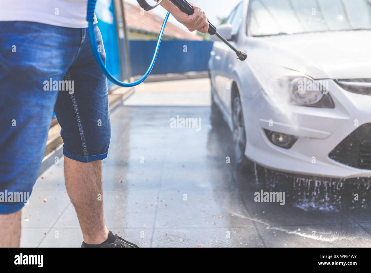 Man washing car wheel with high pressure machine for car wash Stock ...