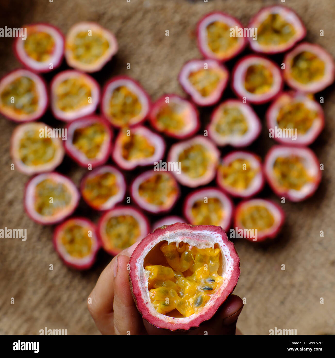 Top view passion fruits cut in half in heart shape background, kind of ...