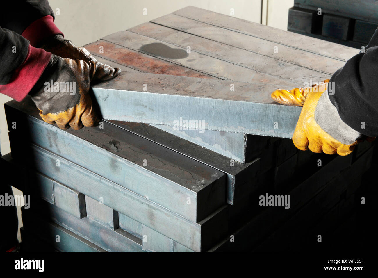 workers and heavy metal blocks Stock Photo - Alamy