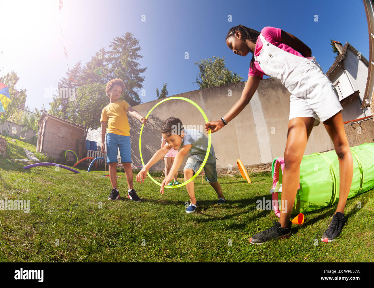 Boy jump through hula hoop ring on playground Stock Photo - Alamy