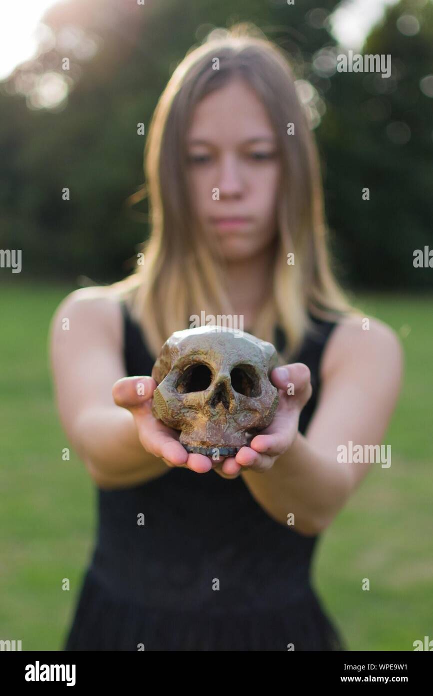 Woman holding skull hi-res stock photography and images - Alamy